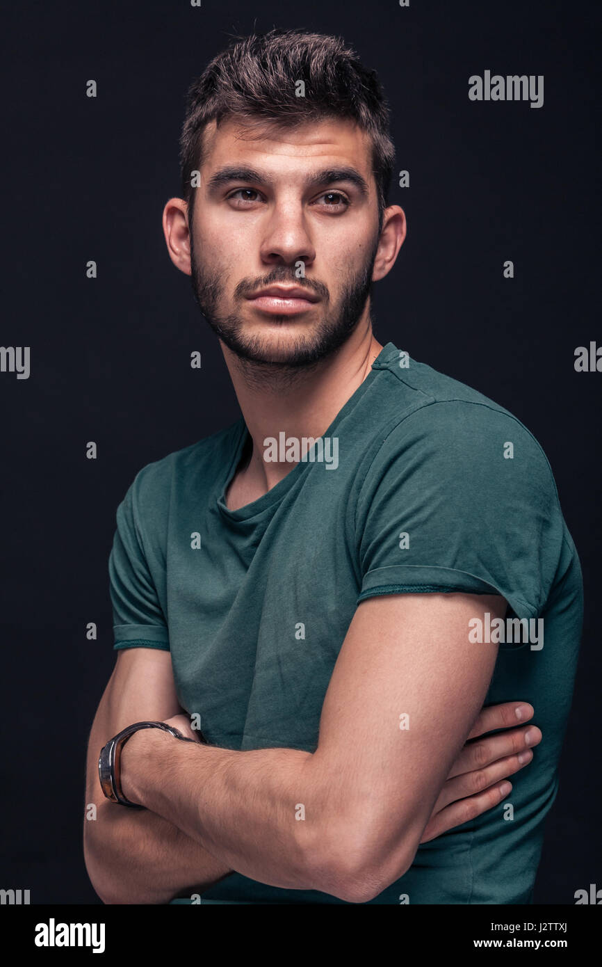 one young man, looking up above, side view, black background, studio ...