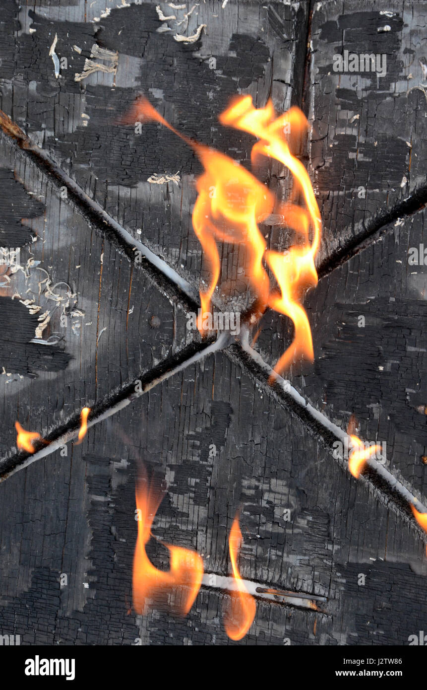 Burning X, a burning wood surface has by coincidence taken the shape of ...