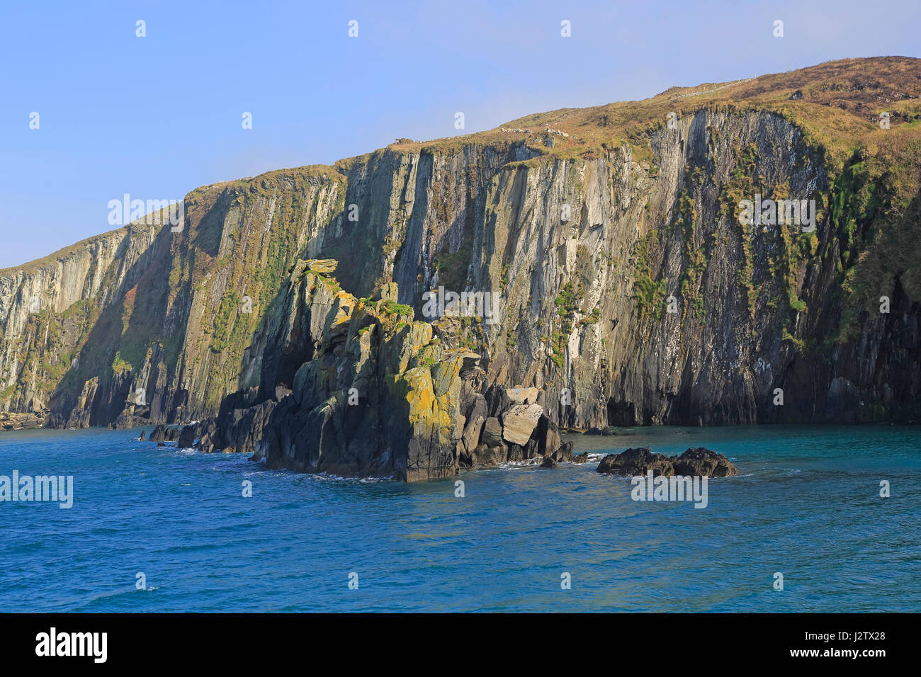 Sheer cliff vertical sedimentary rock strata, west coast Cape Clear ...