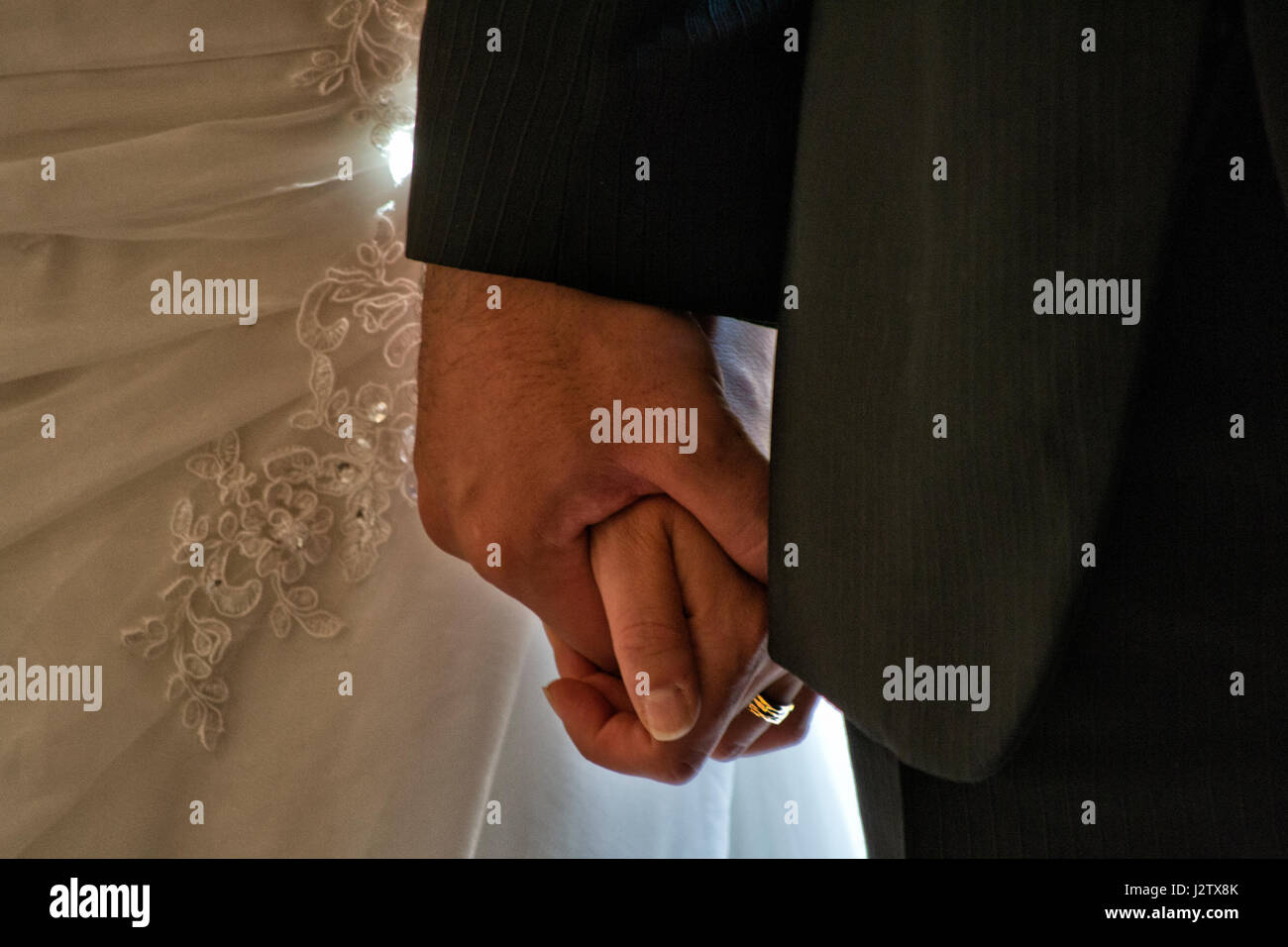 Bride and bridegroom hand by hand Stock Photo - Alamy