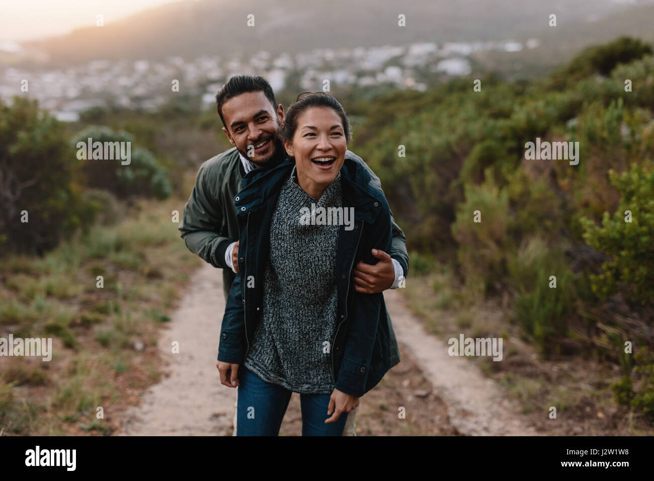 Portrait of happy young couple having fun on their hiking trip. Hiker ...