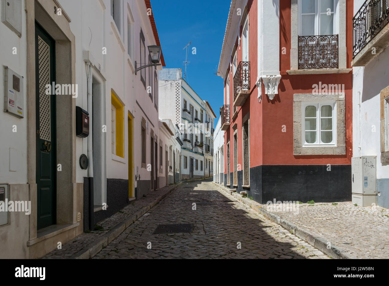 Traditional cobbled street in Tavira old town in the Algarve, Portugal ...