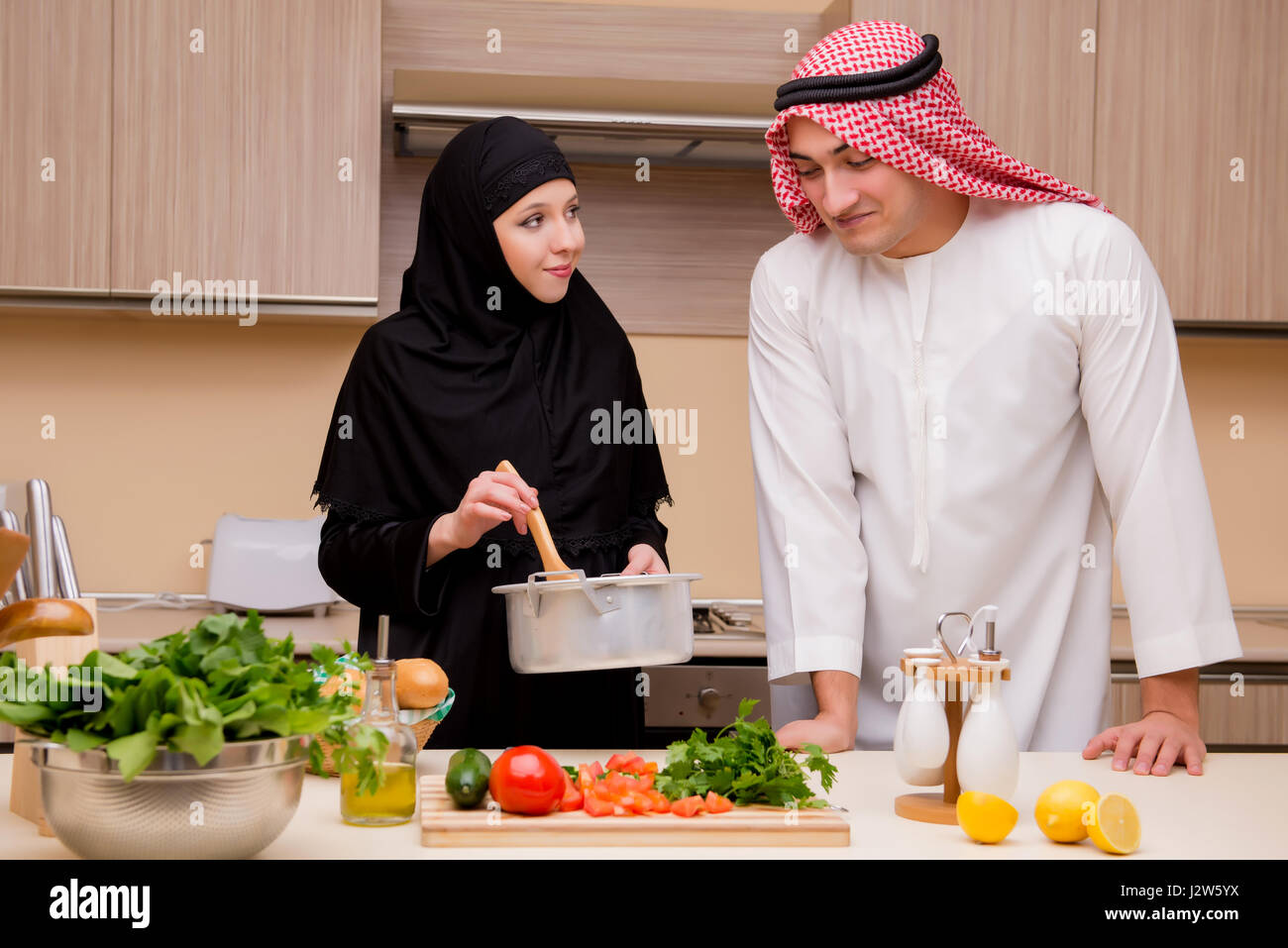 Young arab family in the kitchen Stock Photo - Alamy