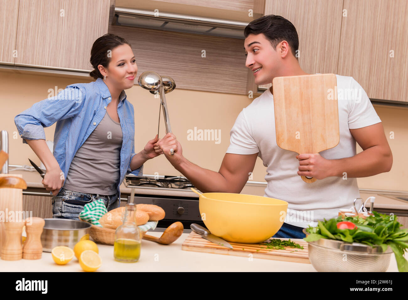 Young family doing funny fight at kitchen Stock Photo - Alamy