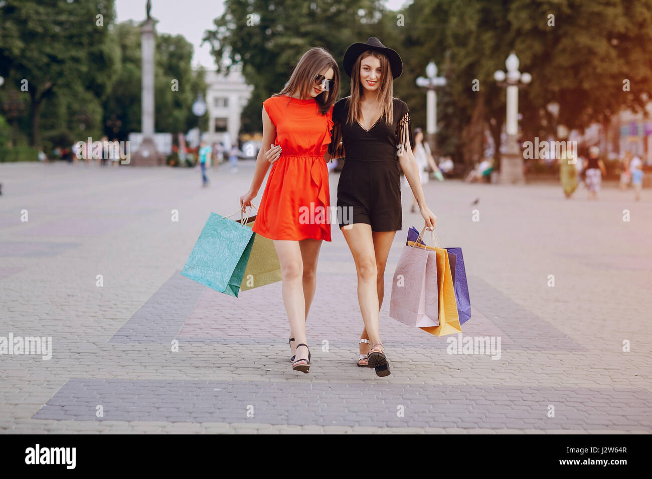 two beautiful young women walk to the shops and make purchases Stock ...