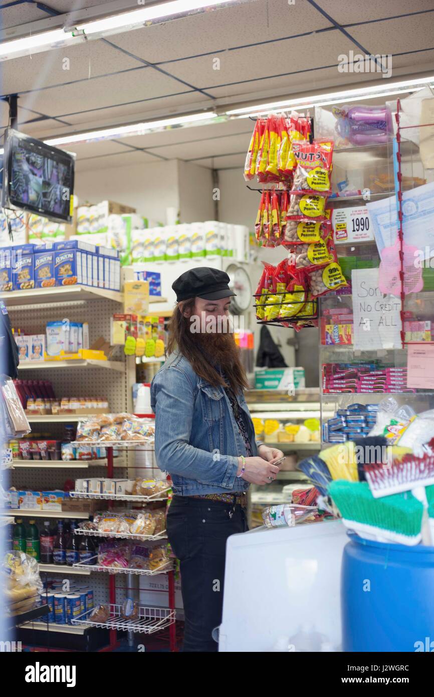 Young man shopping in a convenience store Stock Photo - Alamy