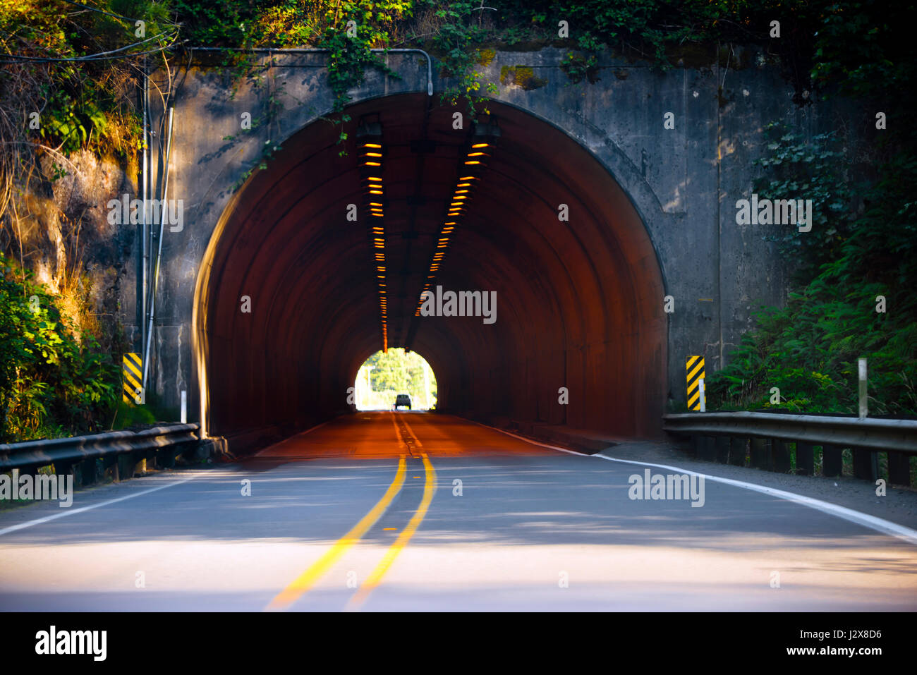 A road with a dividing strip for the opposing traffic flows pass ...