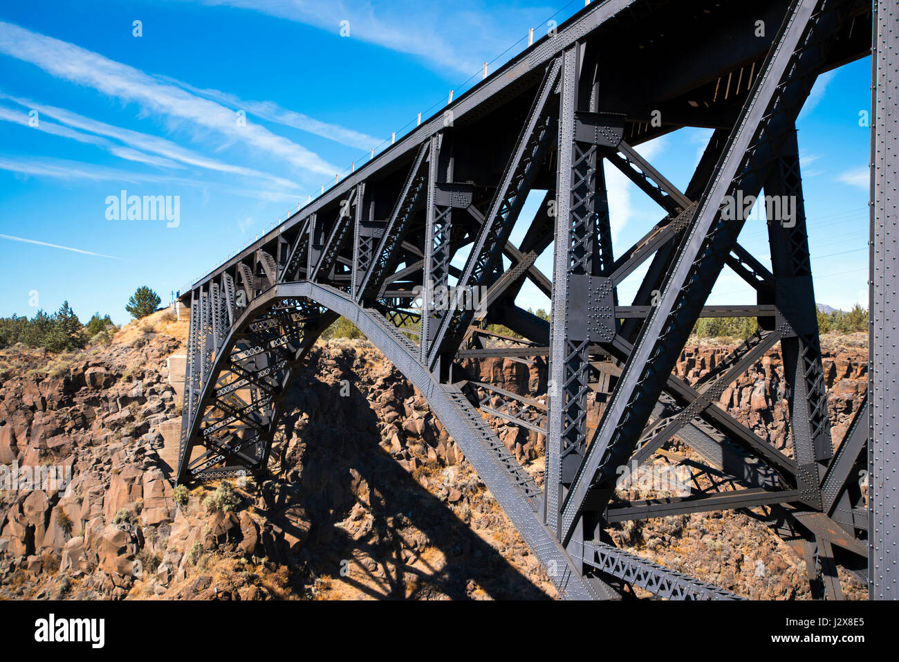 Arched bridge of sectional metal structures connected by rows of rivets ...