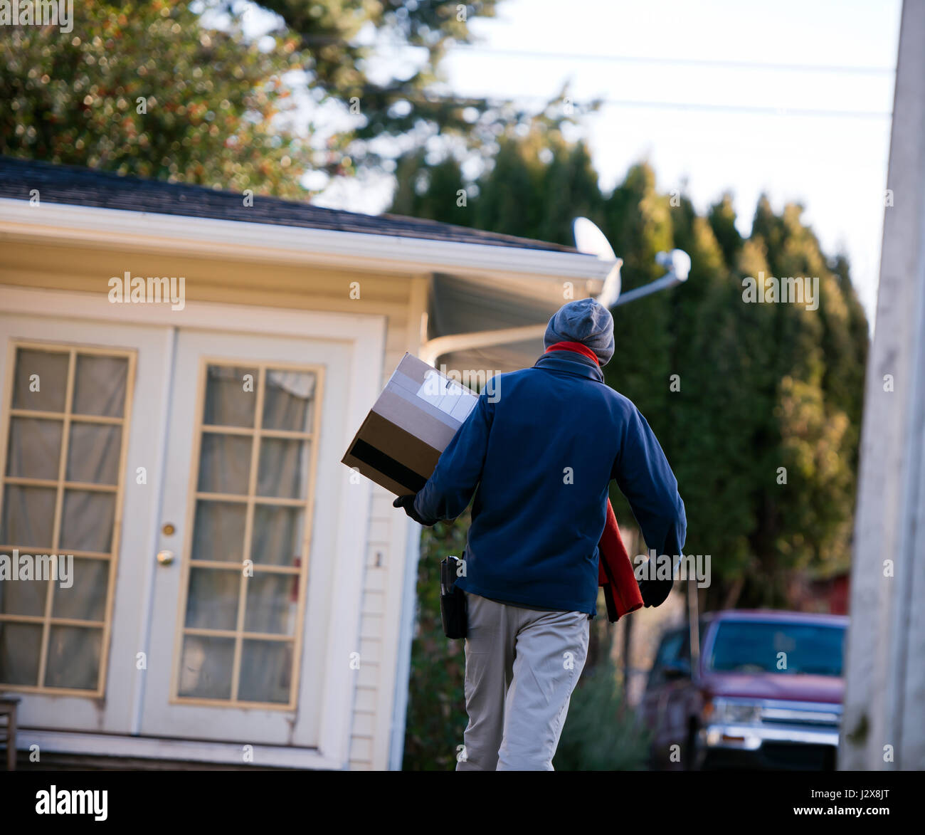 Man on the delivery of parcels with shipped box and a scanner on the ...