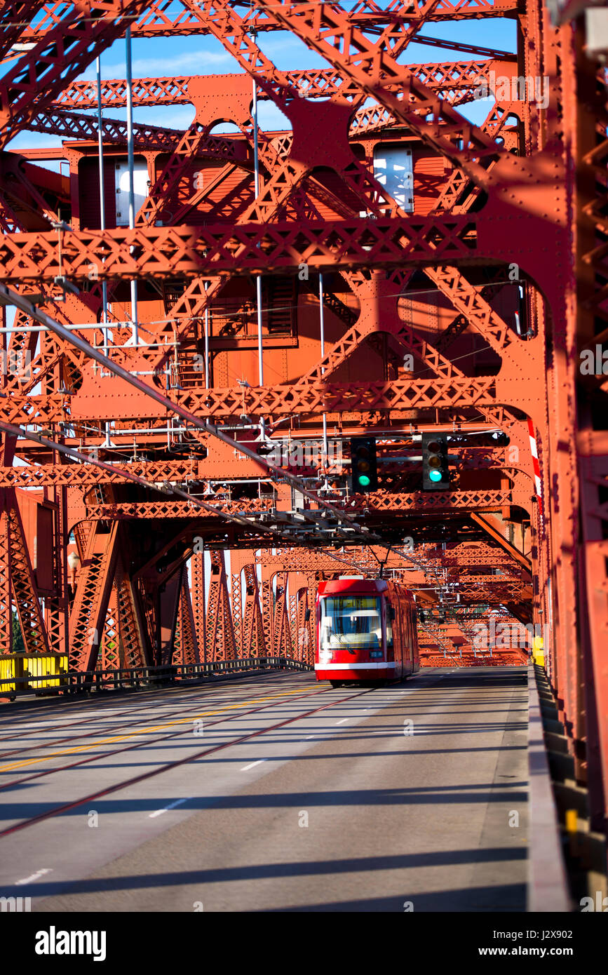 City tram on a red car and a pedestrian drawbridge metal made of ...