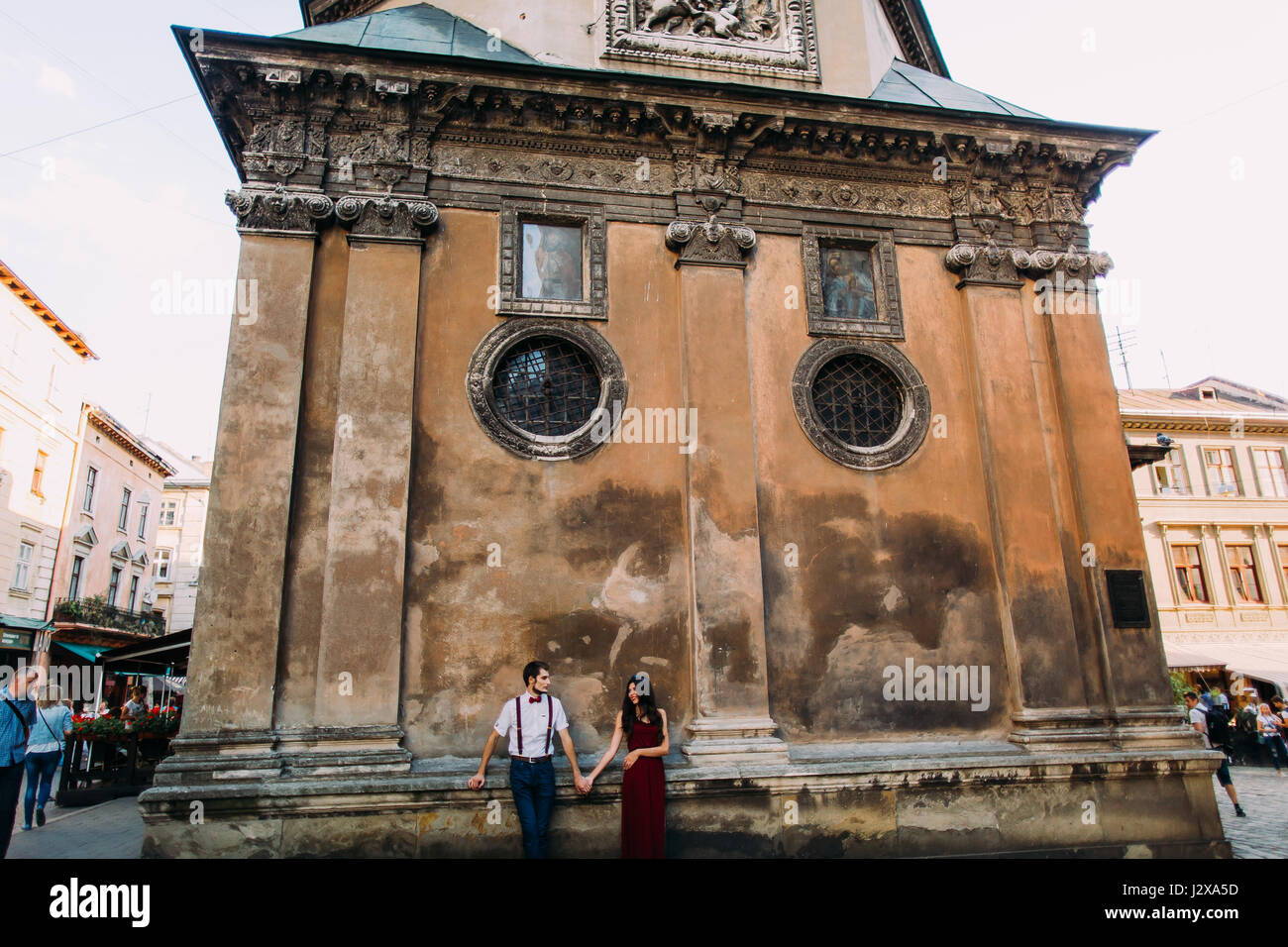 Beautiful luxury dressed stylish couple on a background of Lviv Roman ...