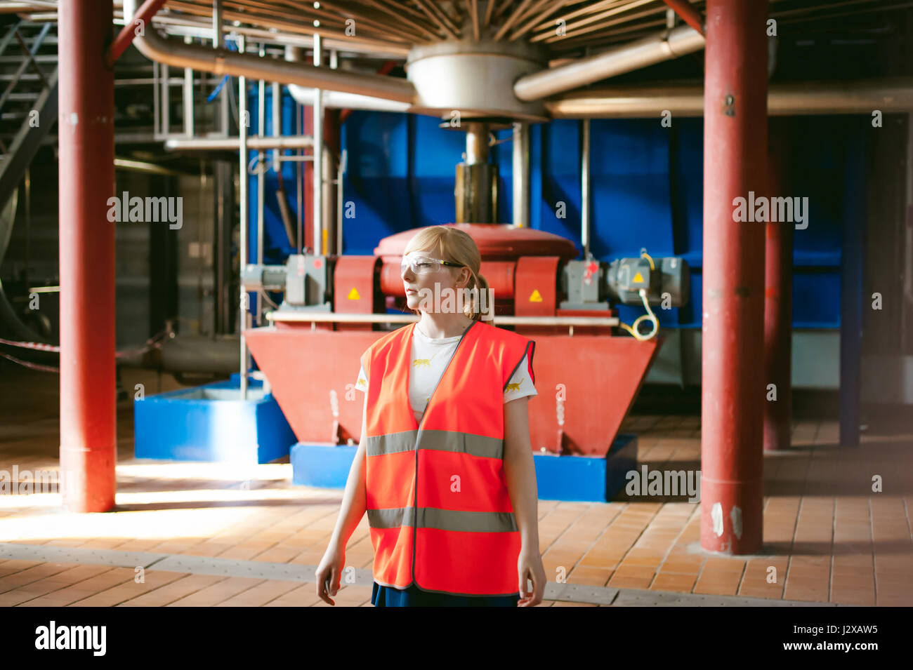 Female worker on beer factory. portrait woman in robe, standing on ...