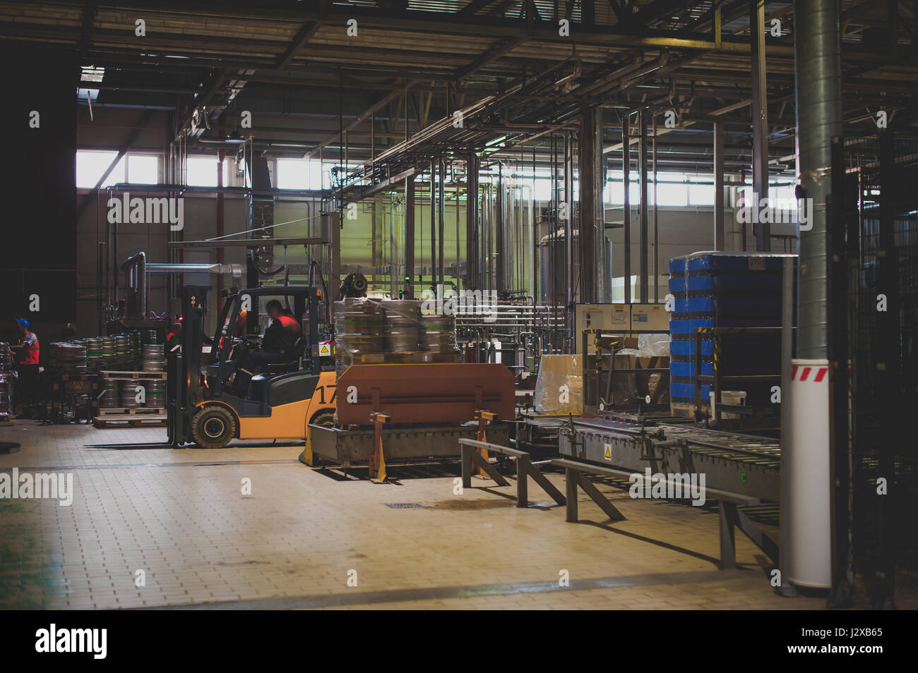 Warehouse employee in Overalls clothes, driver Reachtruck busy working ...