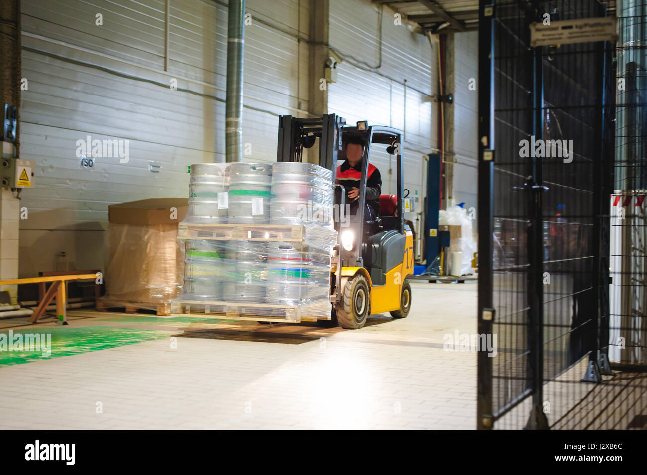Warehouse employee in Overalls clothes, driver Reachtruck busy working ...