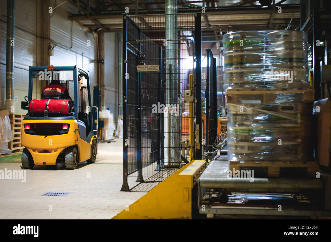 Warehouse employee in Overalls clothes, driver Reachtruck busy working ...