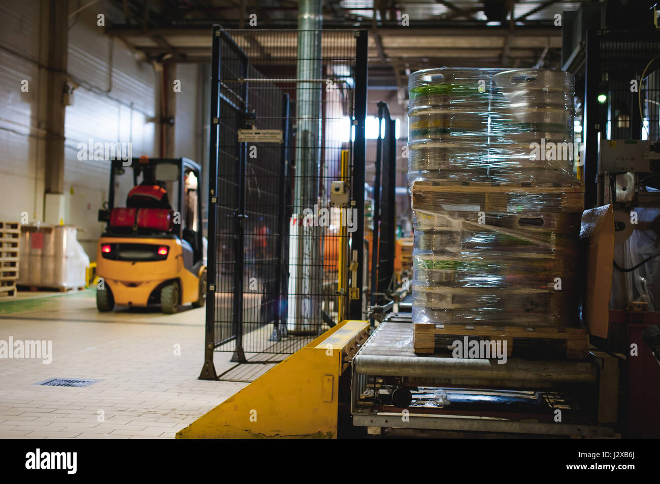 Warehouse employee in Overalls clothes, driver Reachtruck busy working ...