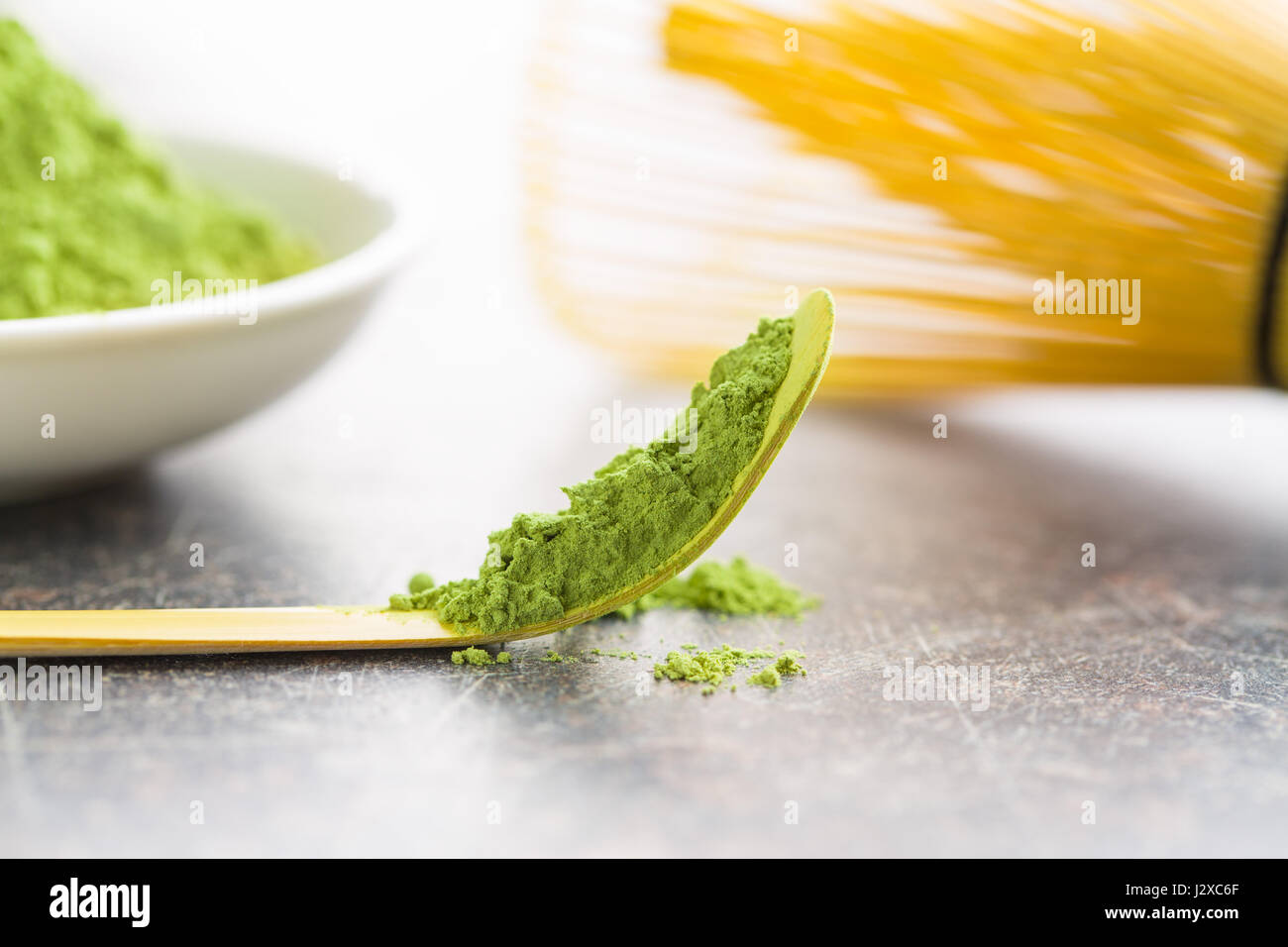 Green matcha tea powder, spoon and bamboo whisk Stock Photo - Alamy