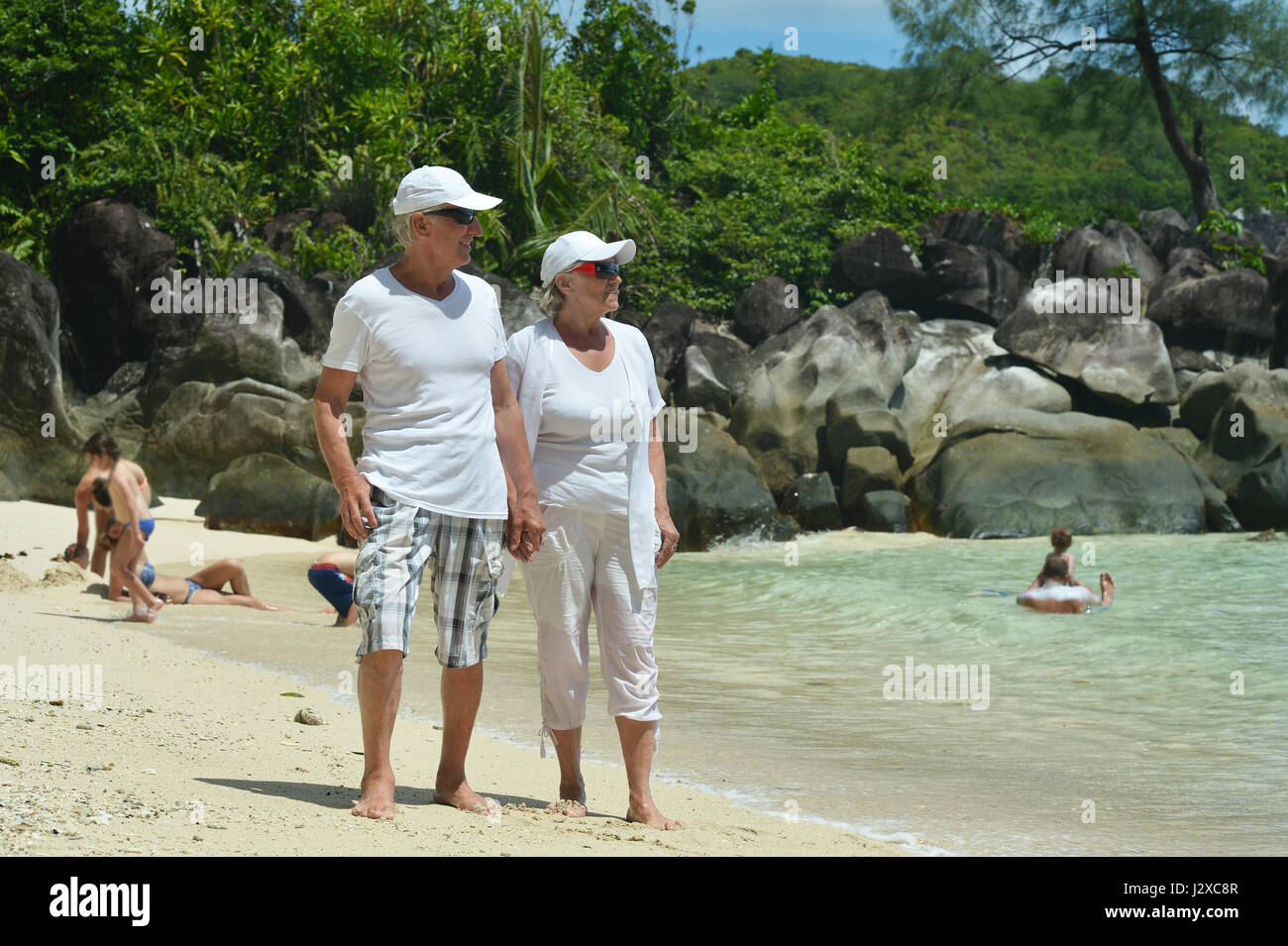 Elderly couple rest at tropical resort Stock Photo - Alamy