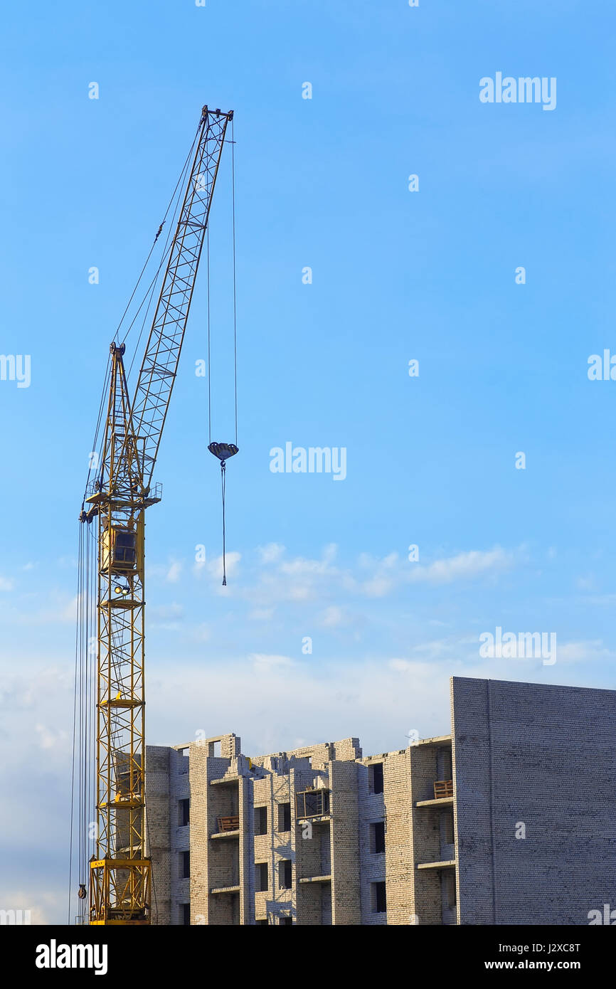 Construction site with crane on sky background. Small construction ...