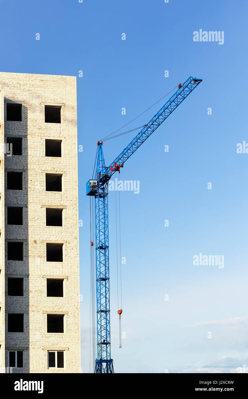 construction site with crane on blue sky background. Small construction ...