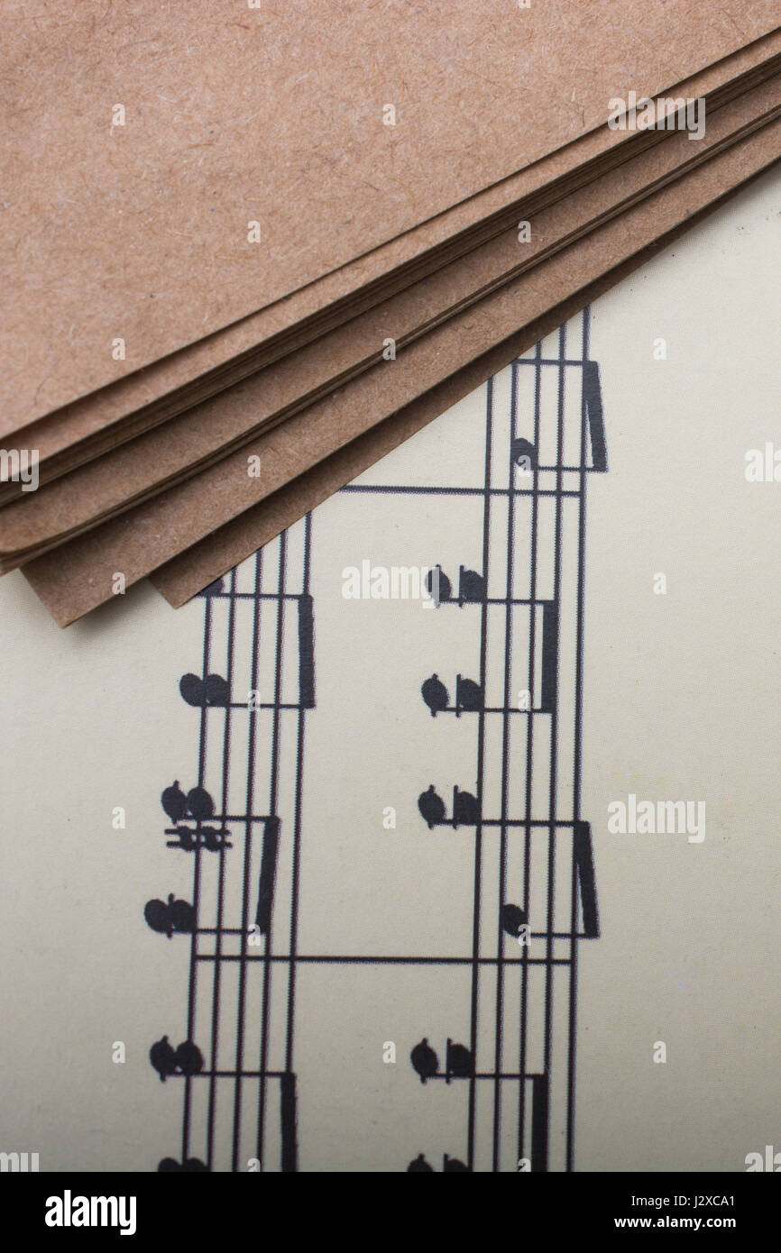 Notebook is on a paper with musical notes Stock Photo - Alamy