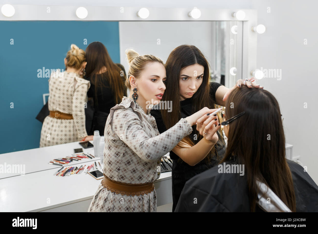 makeup teacher explaining for her student how to apply makeup properly ...