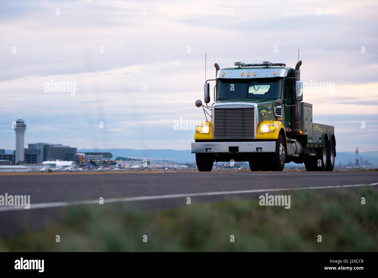 The classic modern stylish big rig semi truck with yellow wings and ...