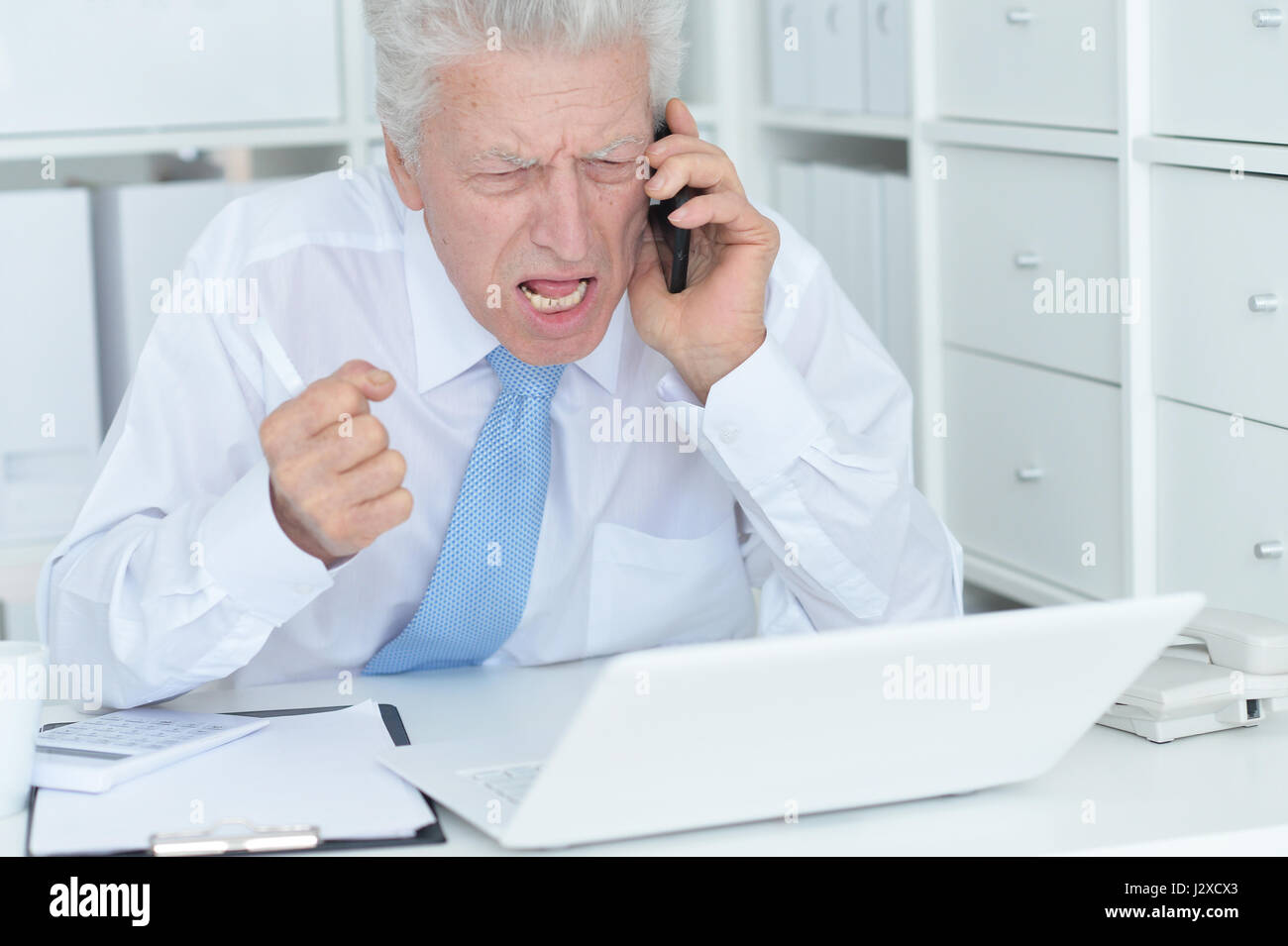 Elderly businessman working in the office Stock Photo - Alamy
