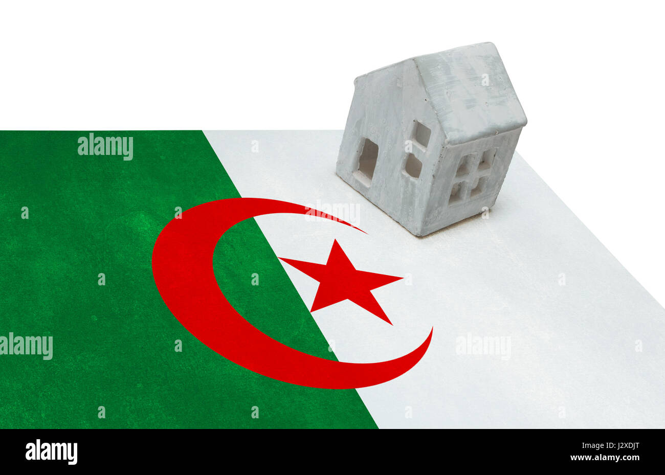 Small house on a flag - Living or migrating to Algeria Stock Photo - Alamy
