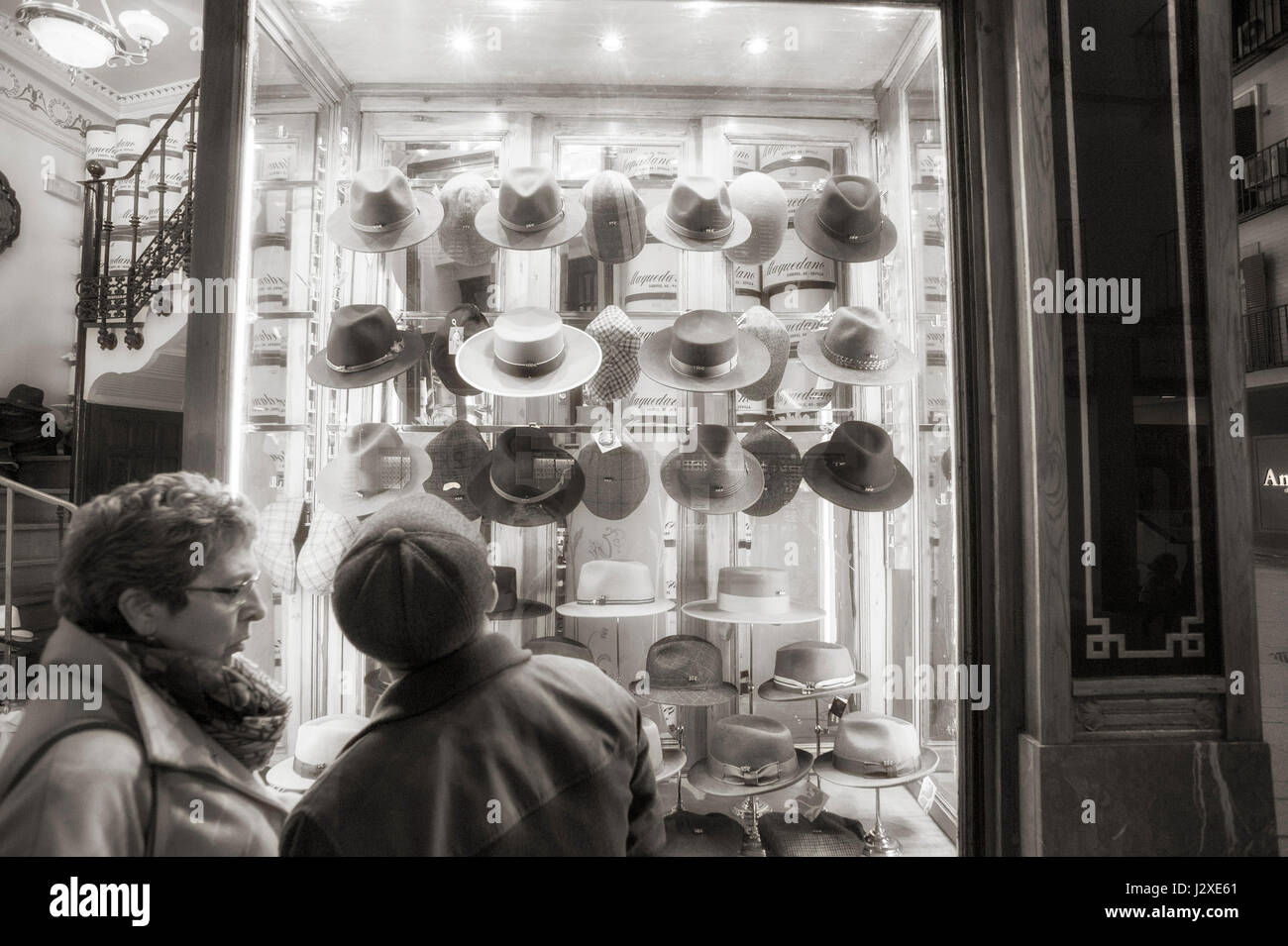 couple in front of window of a traditional hat shop in Seville, Spain ...