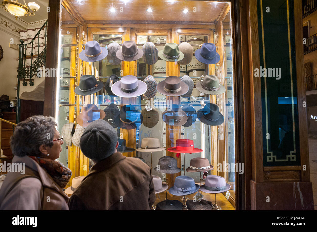 couple in front of window of a traditional hat shop in Seville, Spain ...