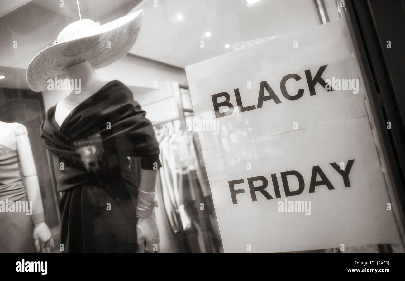 evening dresses in the shop window of fashion boutique with sign ...