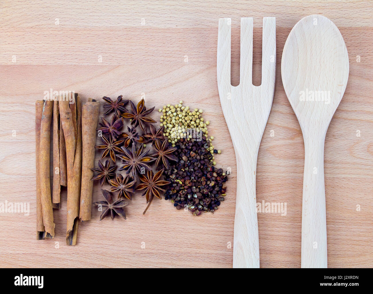 Spices with utensil on wooden background Stock Photo - Alamy