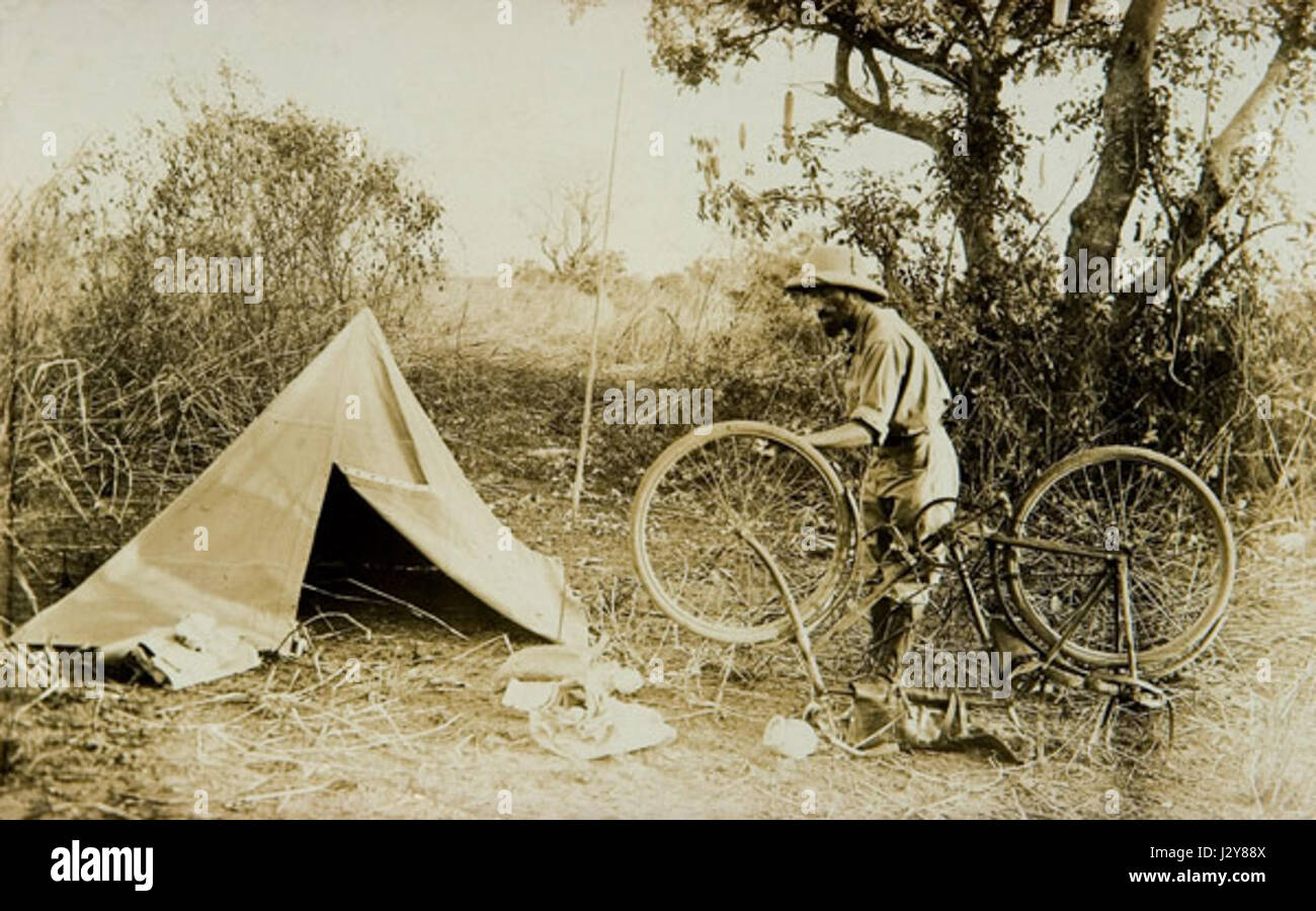 This image shows a person engaged in the act of bicycle mending ...