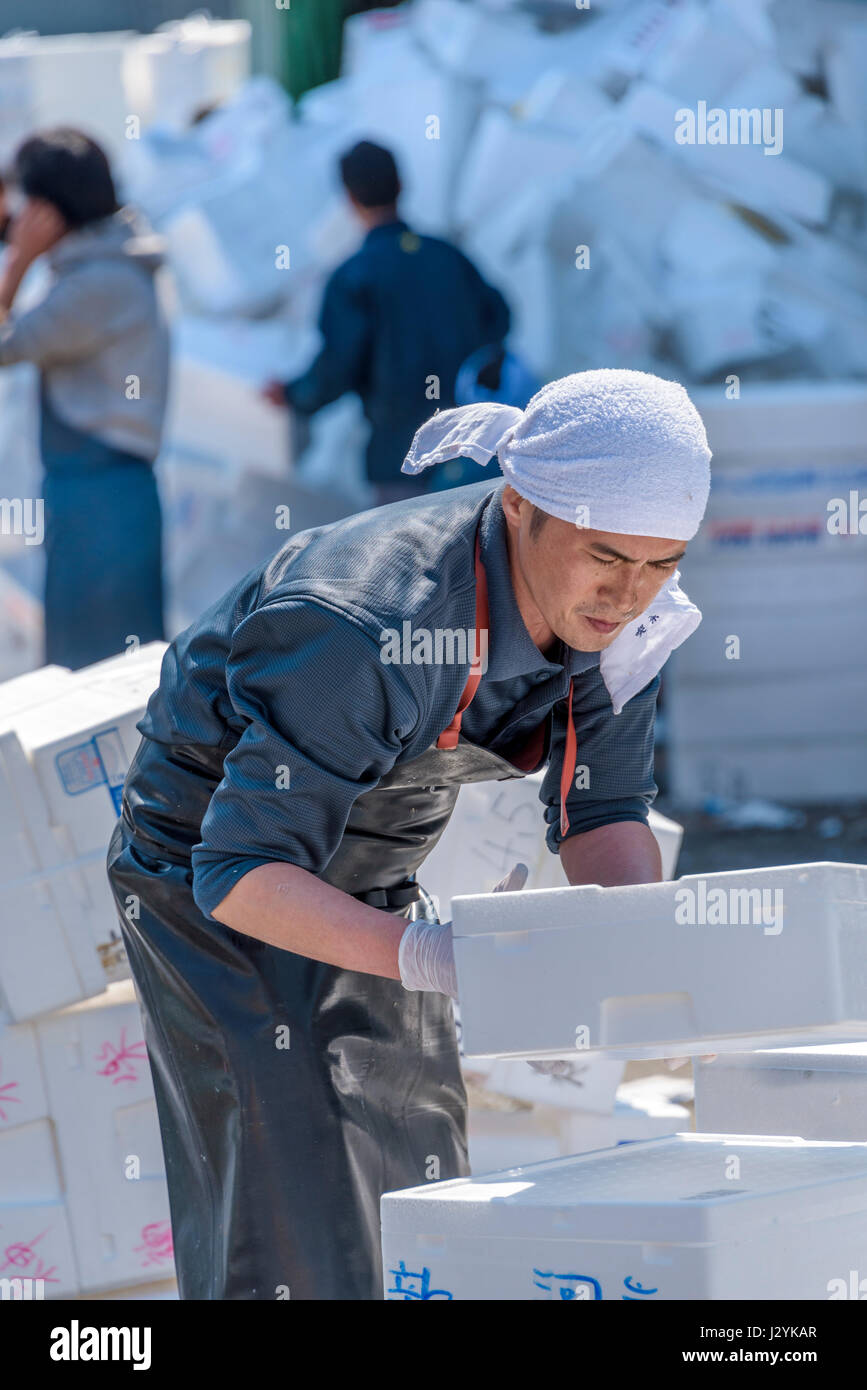 Workers clear away empty polystyrene boxes at the Tsukiji fish market ...
