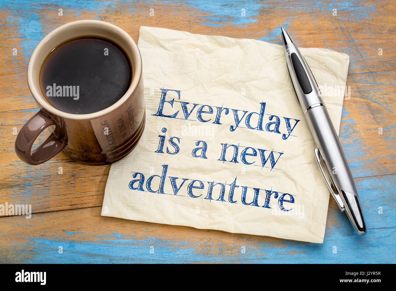 Everyday is a new adventure - motivational text on a napkin with a cup ...