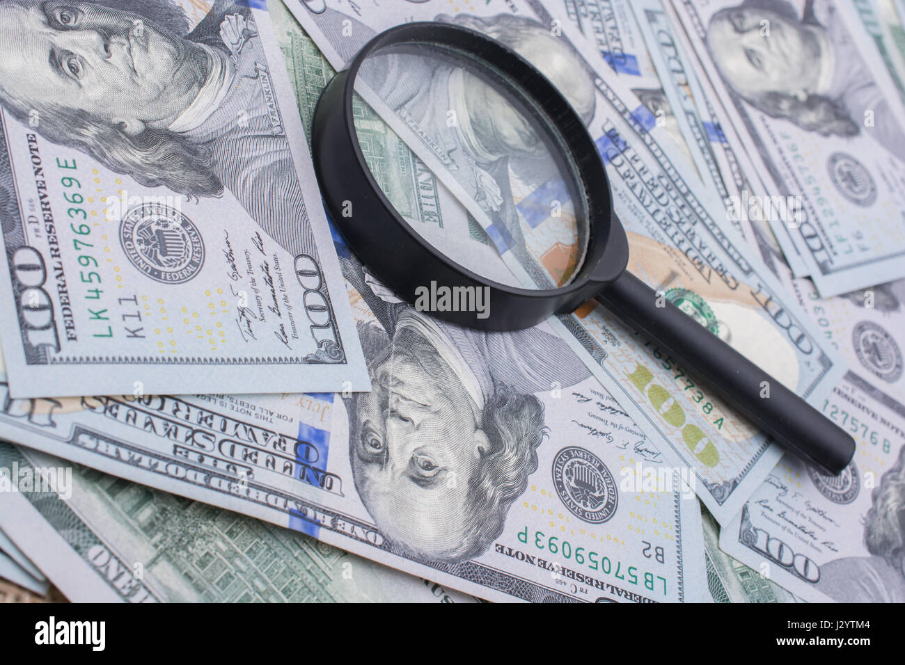 Magnifying glass is placed over of US dollar the banknotes Stock Photo ...