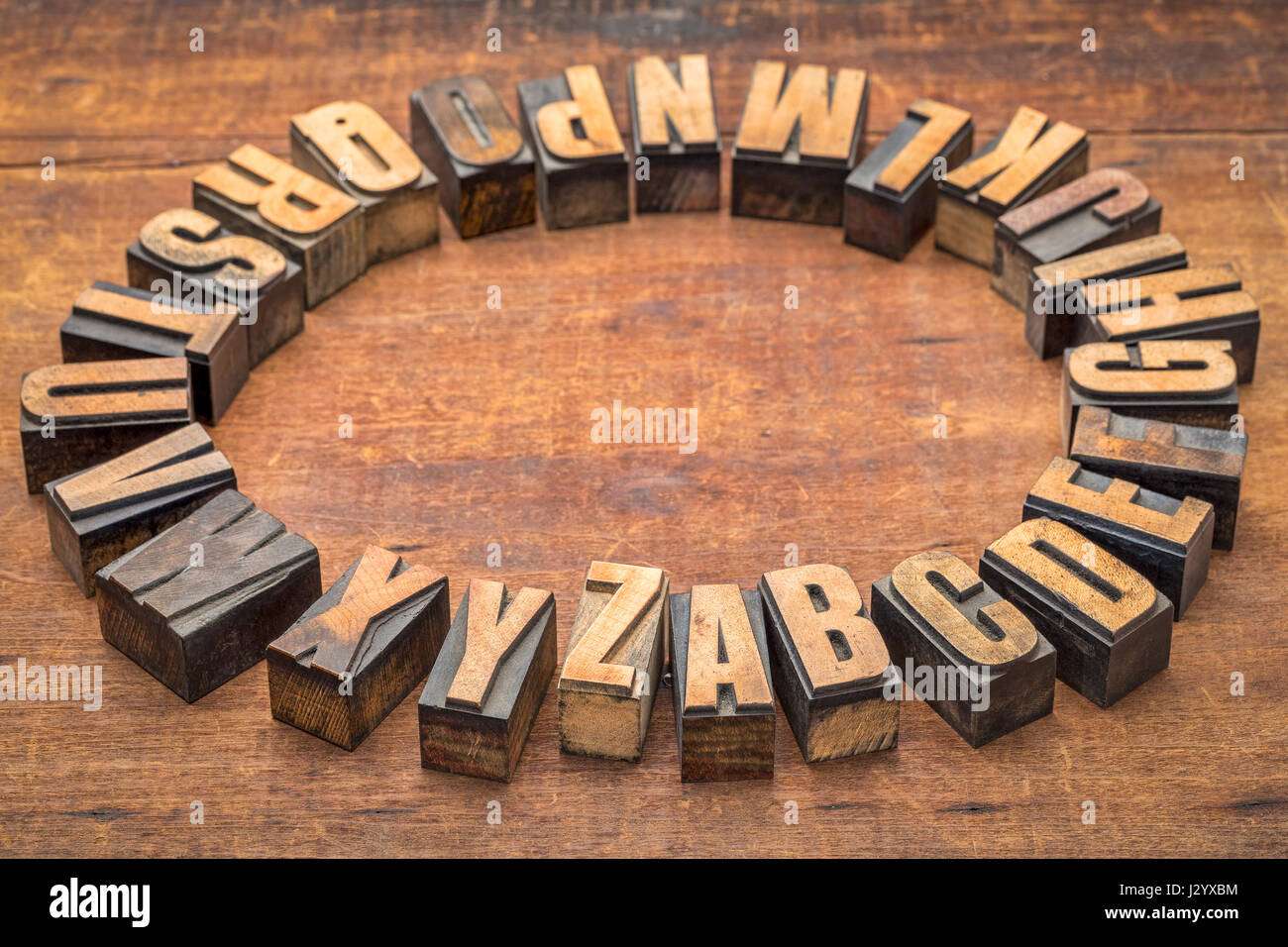 alphabet circle in vintage letterpress wood type against grunge wooden ...