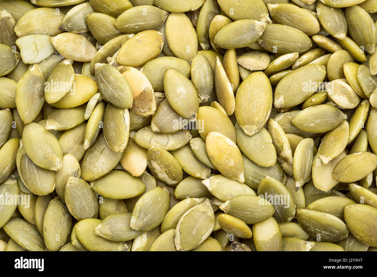 raw, shelled pumpkin seeds background and texture Stock Photo - Alamy