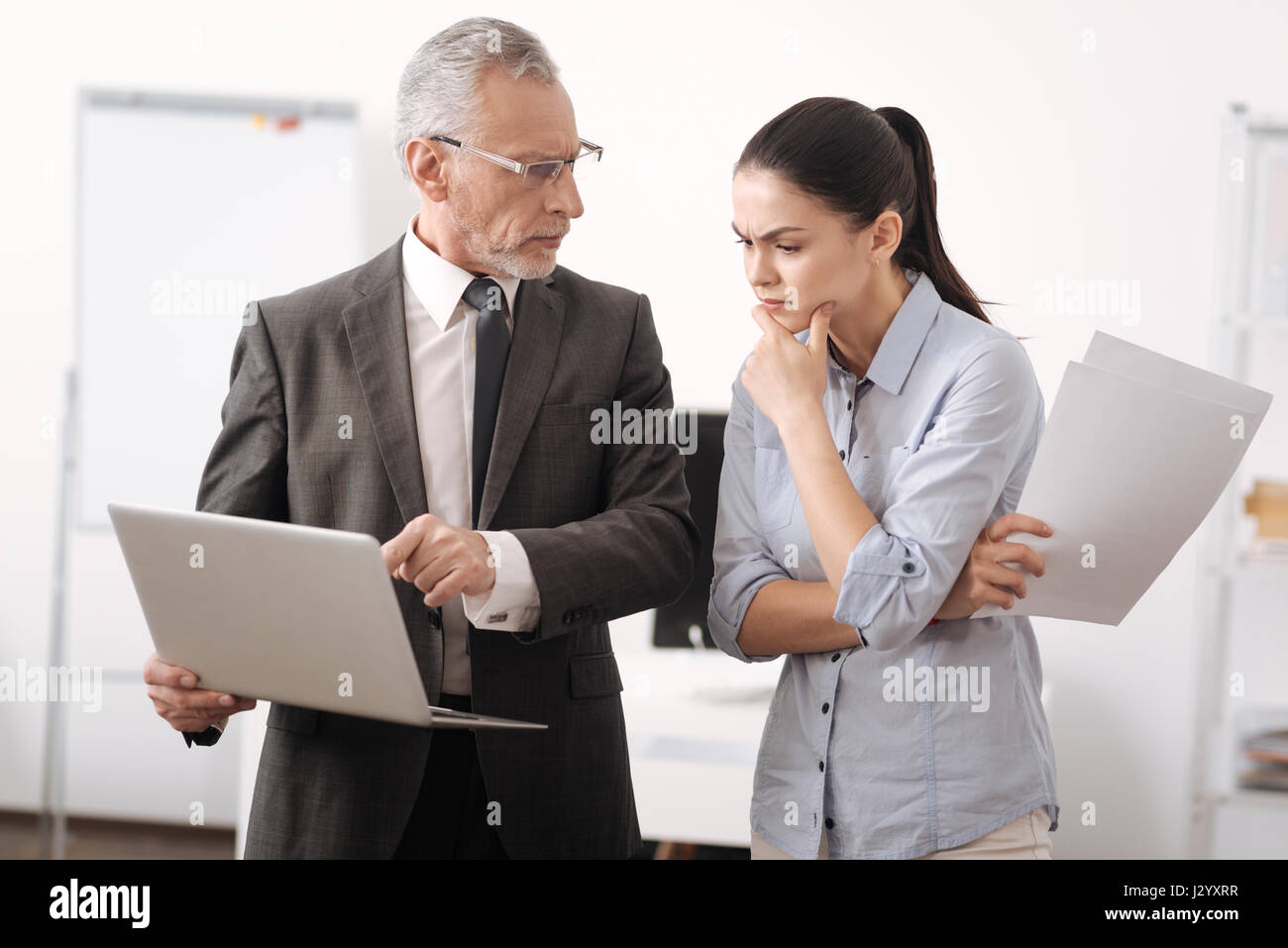 Angry boss using laptop while working Stock Photo - Alamy