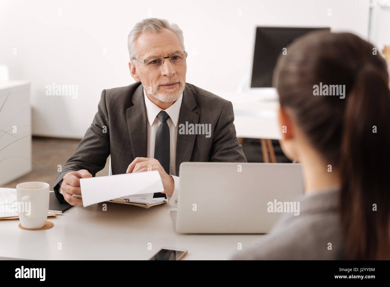 Kind male person looking at his secretary Stock Photo - Alamy