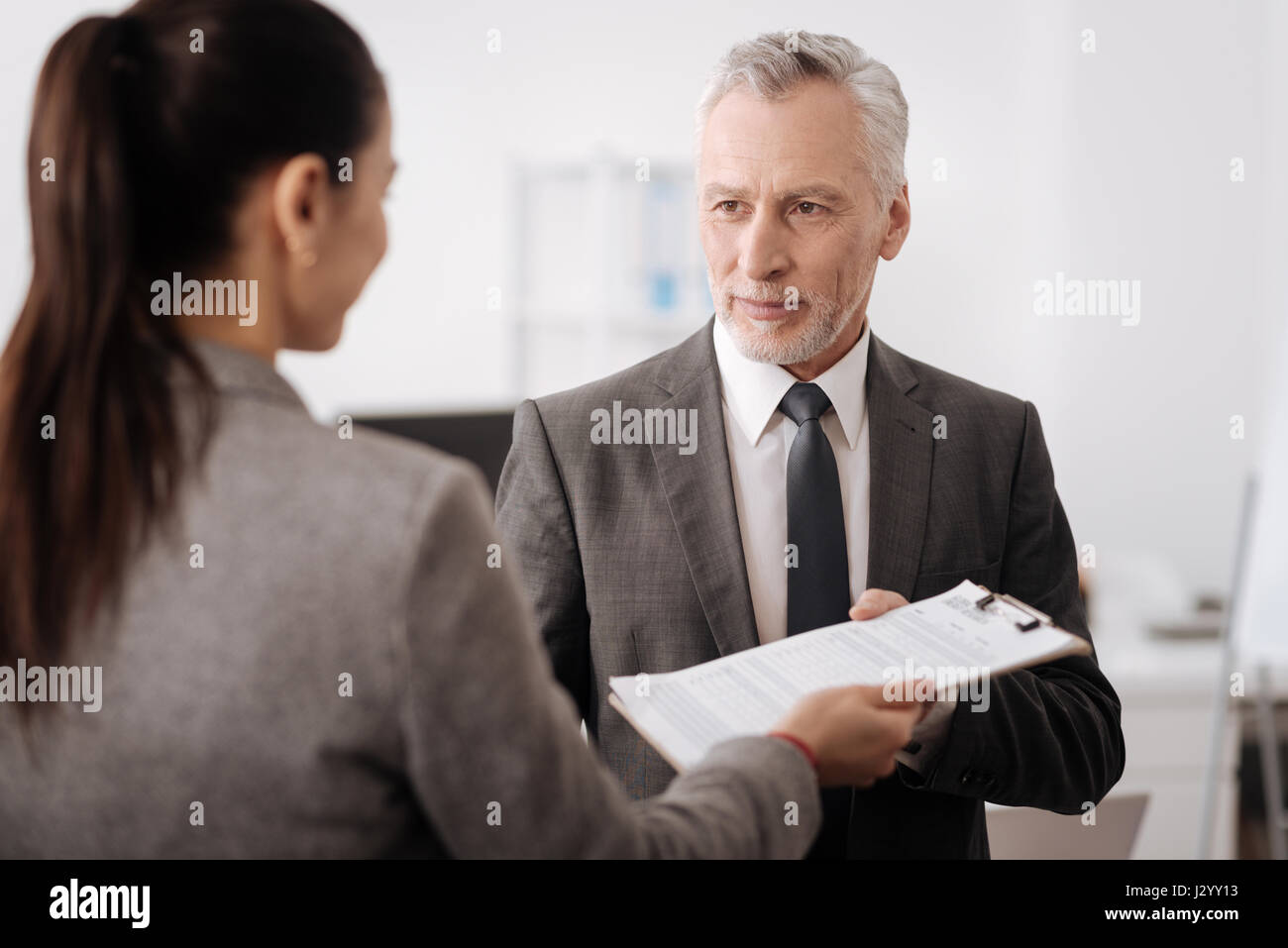 Handsome delighted male person taking documents Stock Photo - Alamy