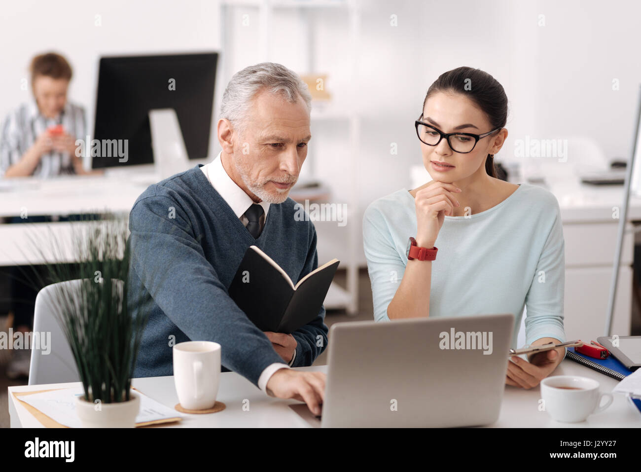 Very attentive man looking at computer Stock Photo - Alamy