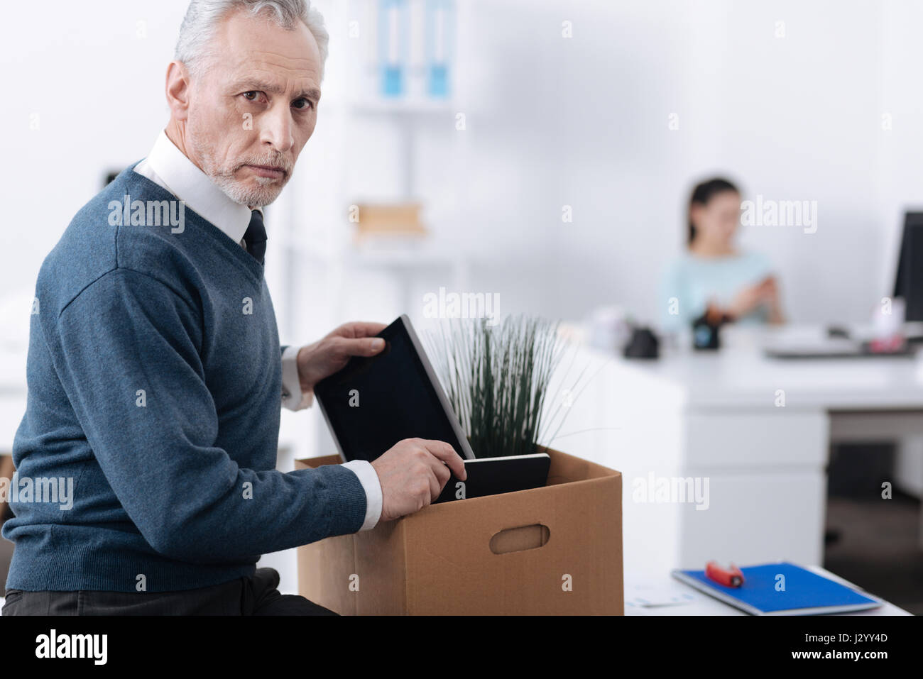 Sad male person looking straight at camera Stock Photo - Alamy