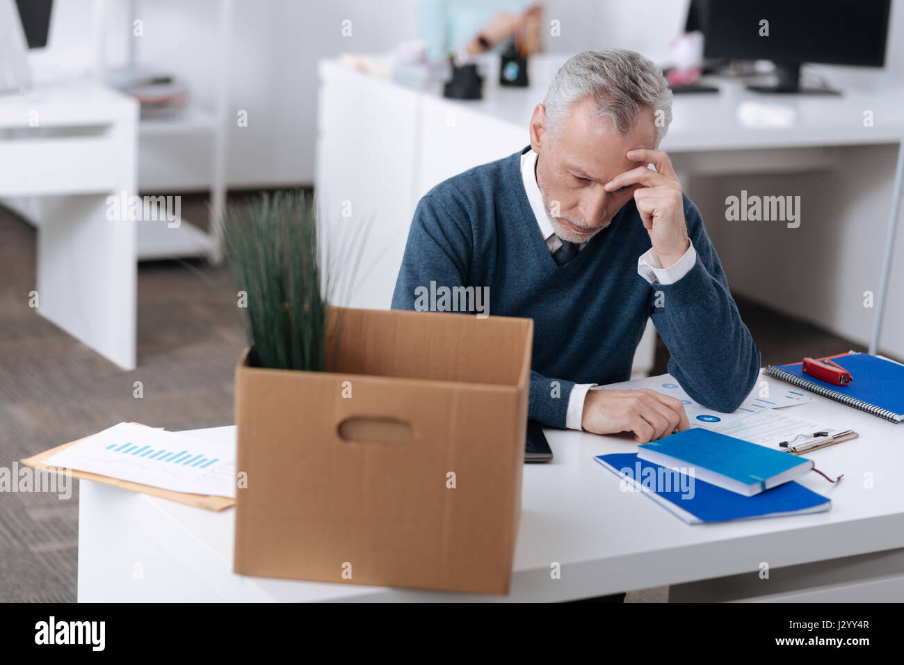 Upset male office worker being deep in thoughts Stock Photo - Alamy