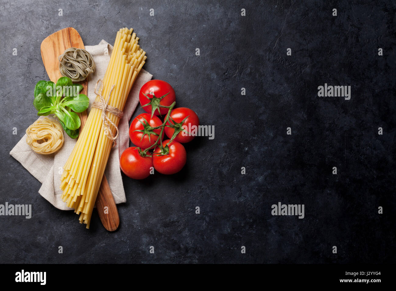 Pasta and ingredients on stone table. Top view with copy space Stock ...