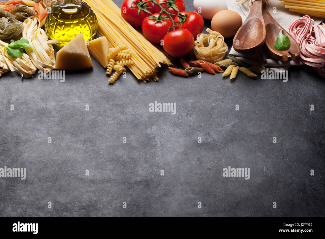 Pasta and ingredients on stone table. Top view with copy space Stock ...