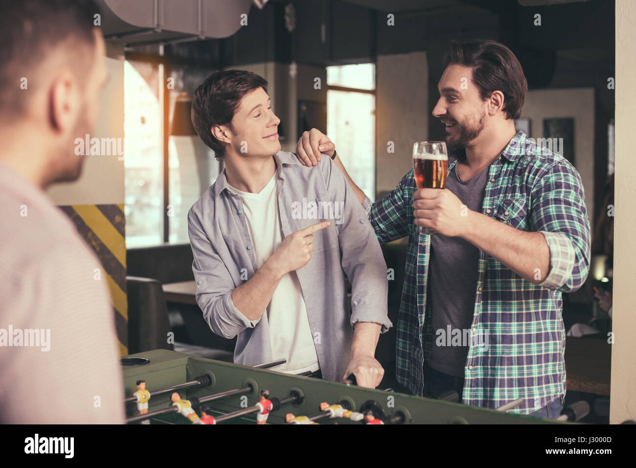 Friends having fun in pub Stock Photo - Alamy
