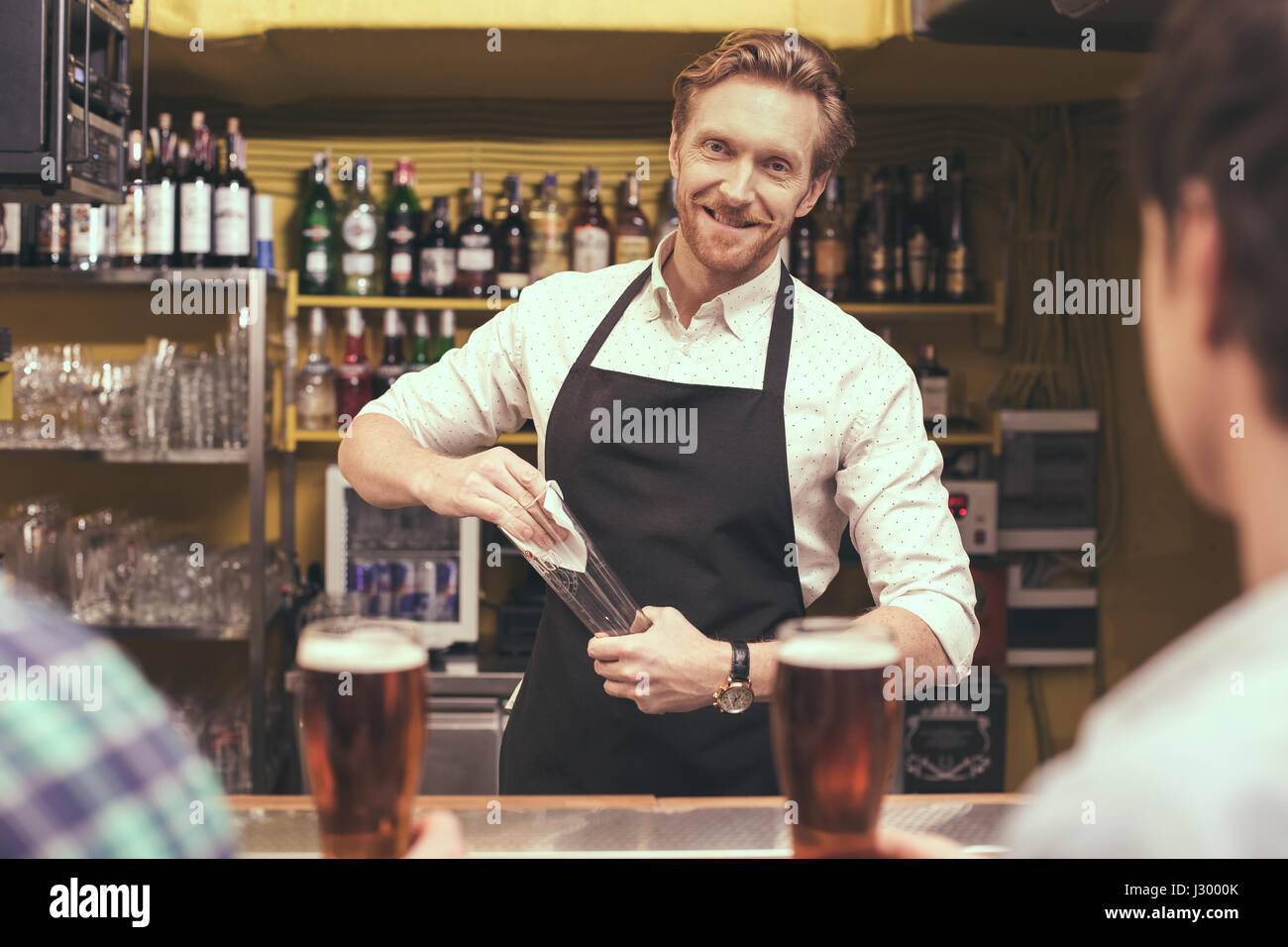 Friends having fun in pub Stock Photo - Alamy