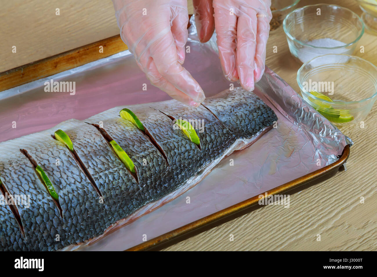 Delicious marinated fillet fish with lemon and onion dish in the oven ...